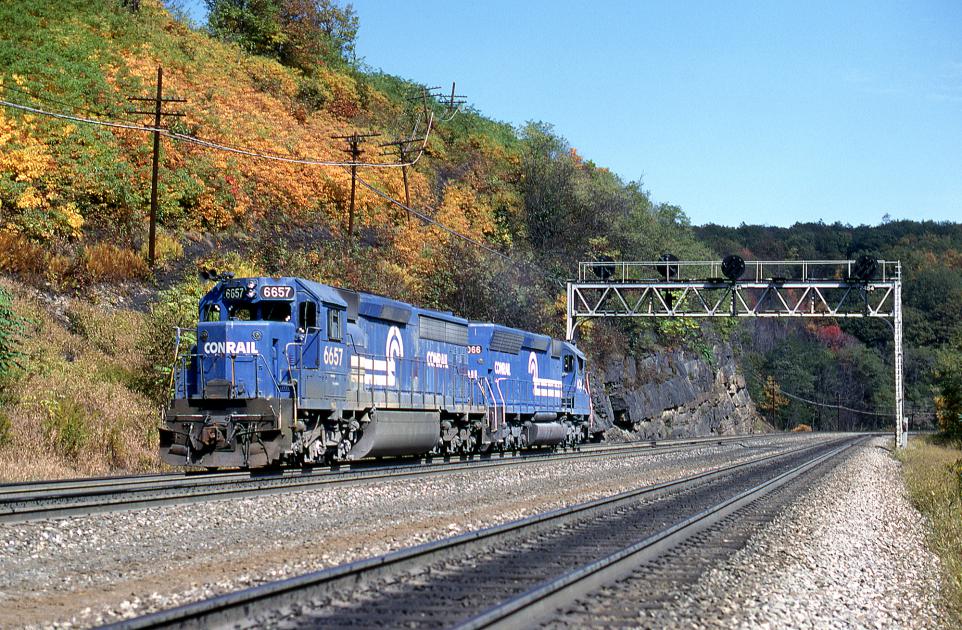 CR 6657 leads a light helper set upgrade east of Bennington Curve, 10/82 | Conrail Photo Archive